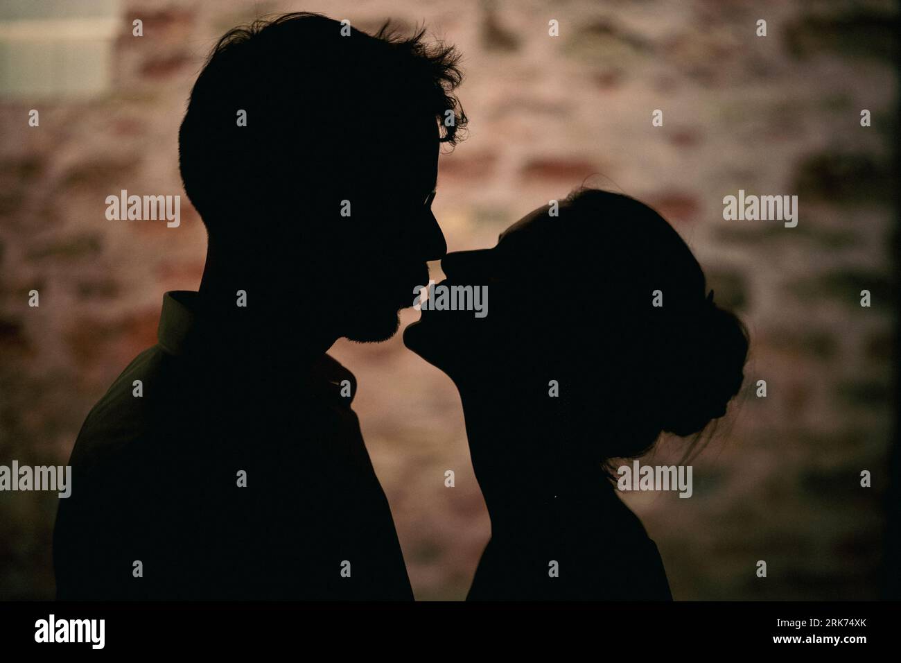 A silhouette of a romantic couple sharing an intimate moment together ...