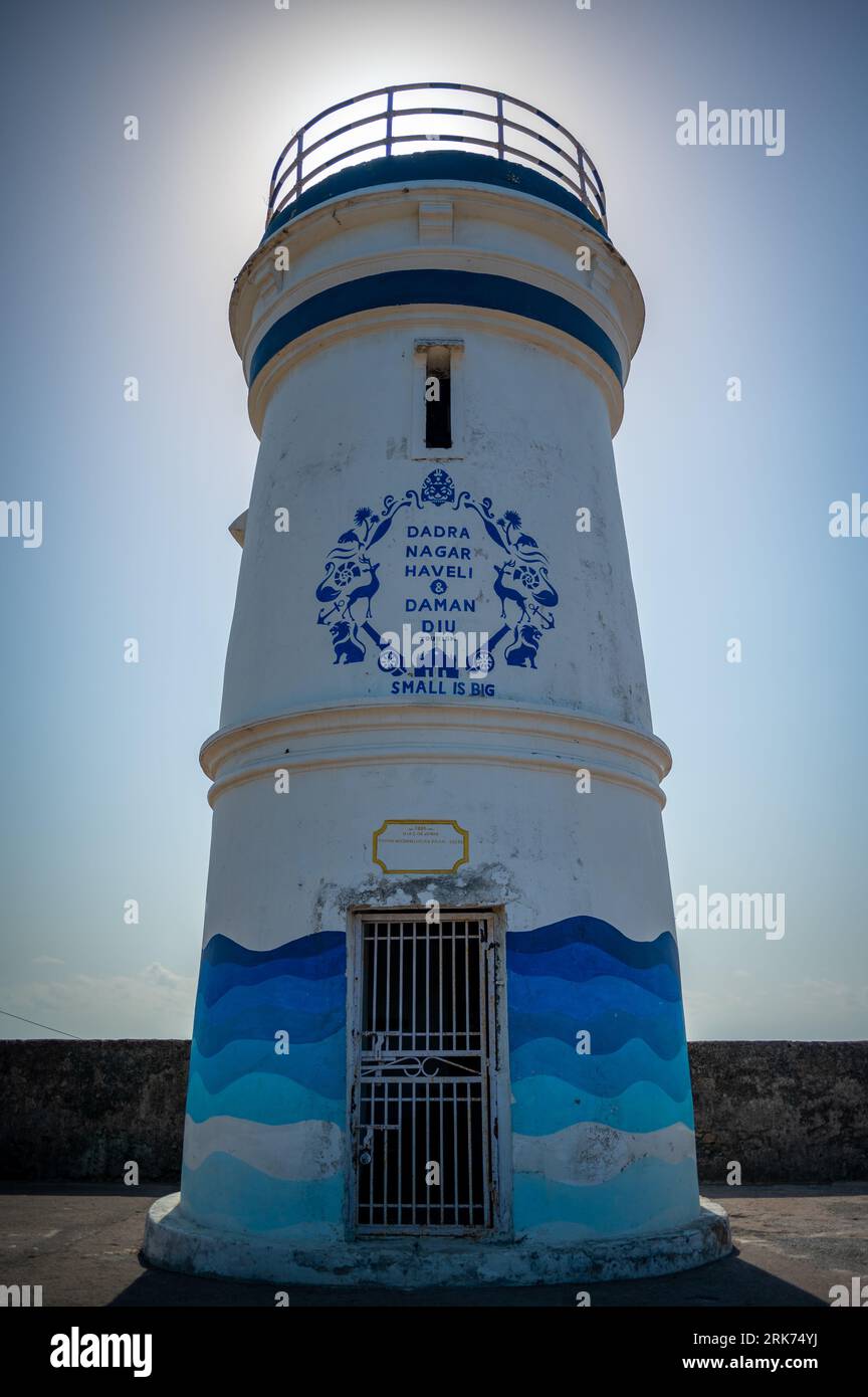 A picturesque scene of an Old lighthouse in Daman with a blue and white ...