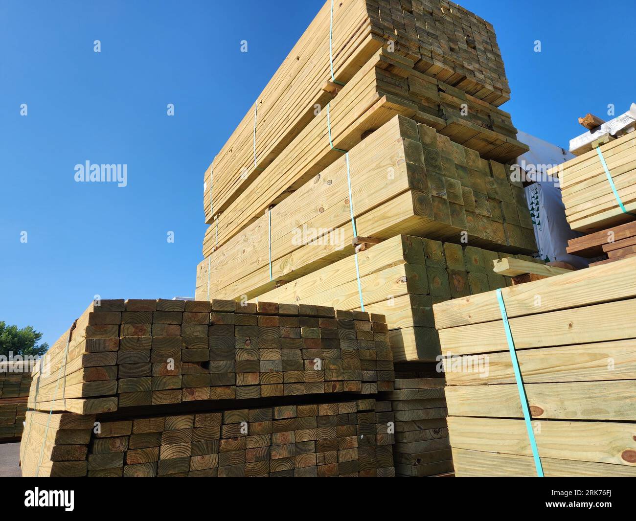 A low angle of a stack of lumber with a clear blue sky above Stock ...