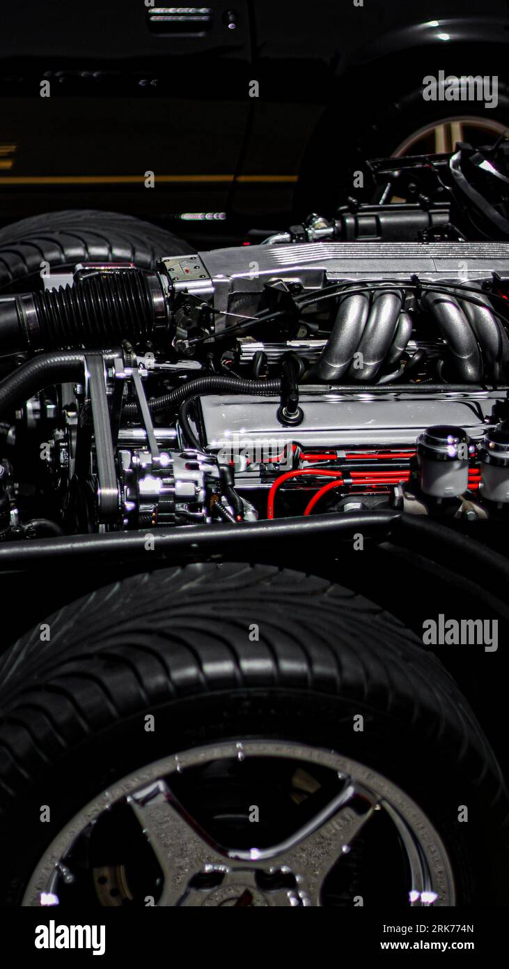 A vivid, close-up of an automobile engine, with visible details of the ...