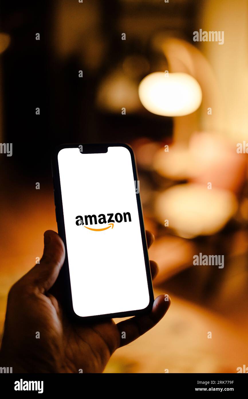 A modern-looking smartphone with an Amazon logo displayed on the screen ...