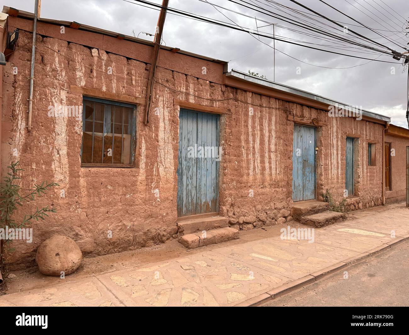 A vintage-style building with blue doors in contrast against an open ...