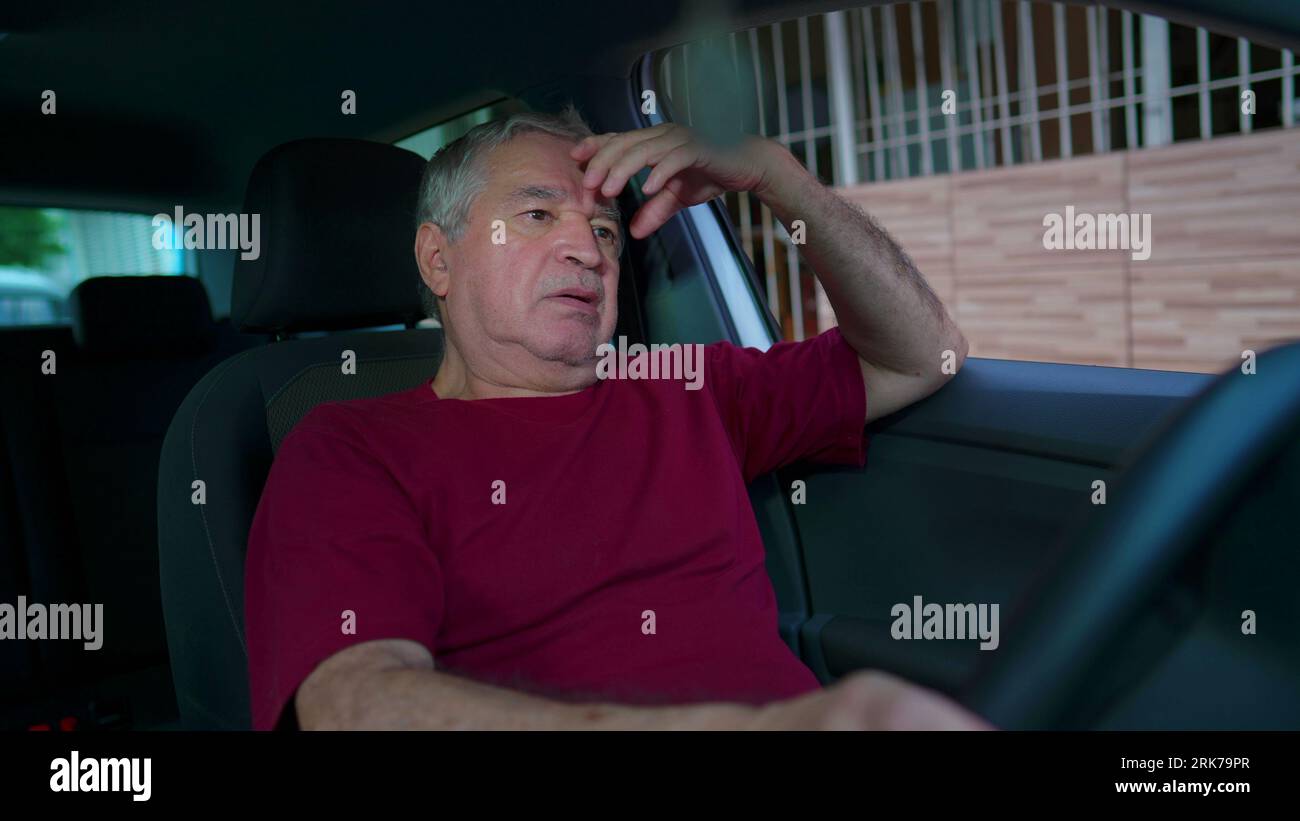 Anxious senior man inside vehicle interior suffers from worries and ...