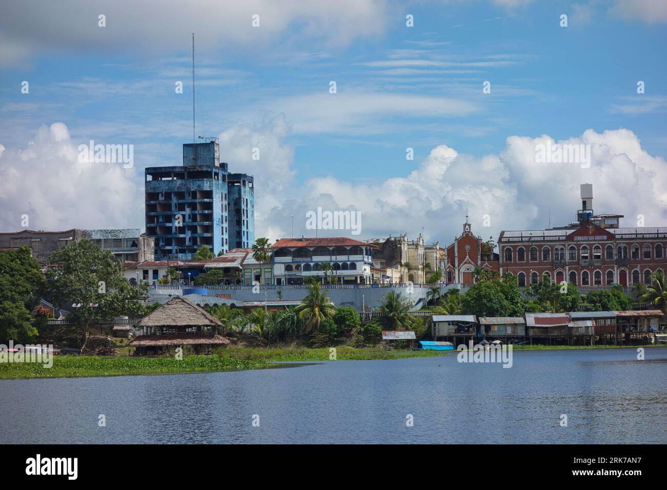 An aerial view of a cityscape featuring a large body of water, with ...