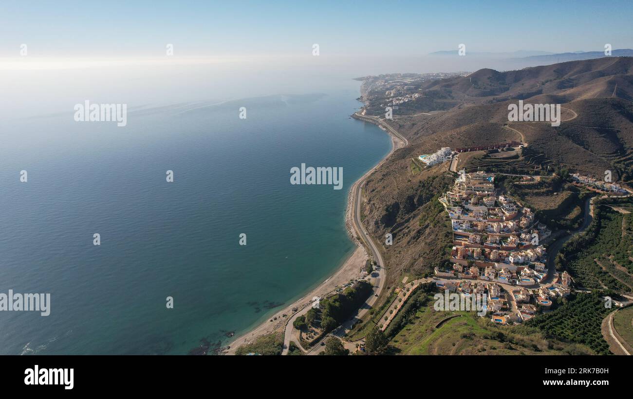 Aerial view of a sandy beach with a few beachfront houses in the ...