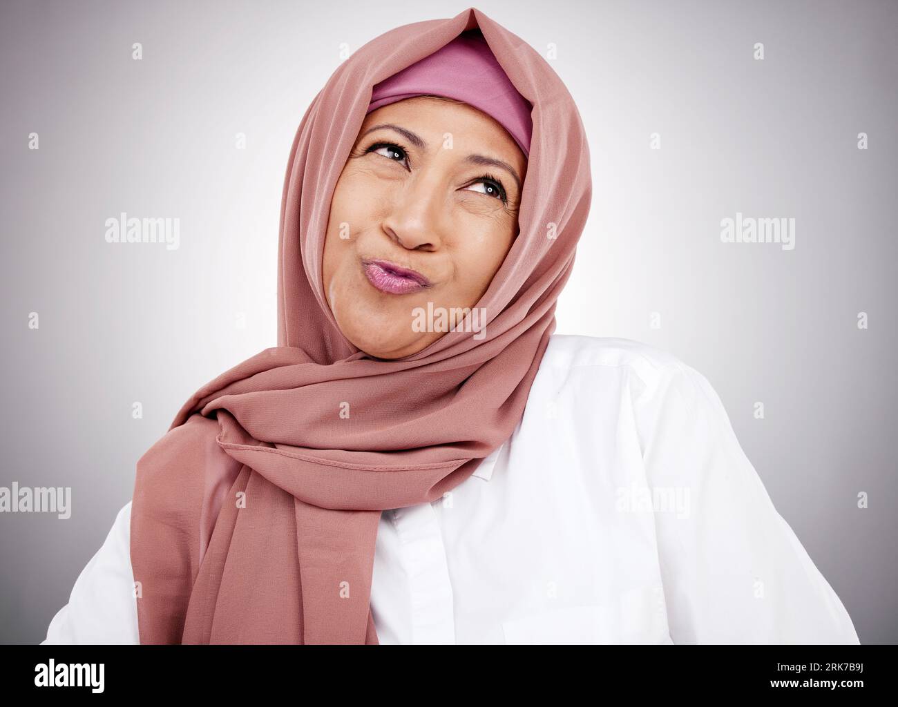 Smile, pouting and a Muslim woman on a studio background with hijab for ...