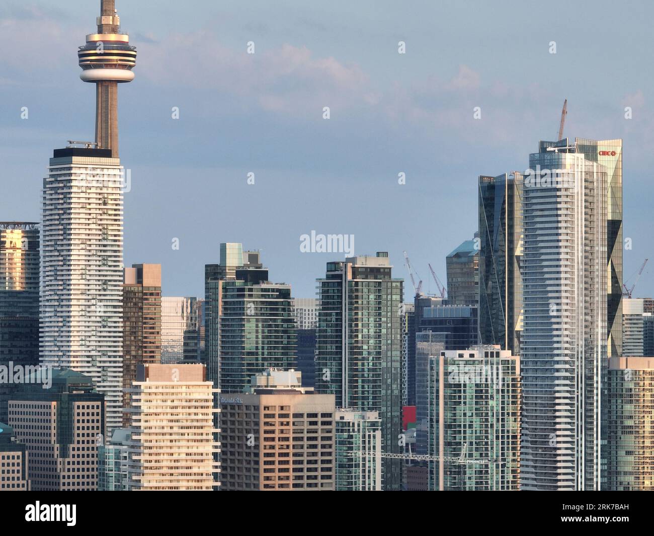 Downtown Toronto at morning golden hour, building rooftops and a peak ...