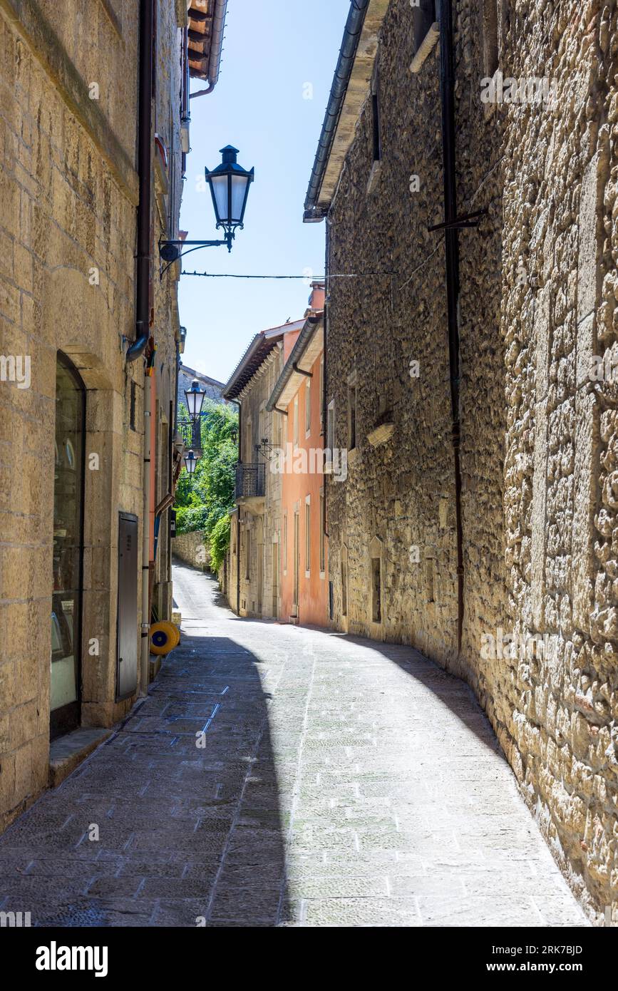 A traditional cobblestone street with old buildings lining the road in ...