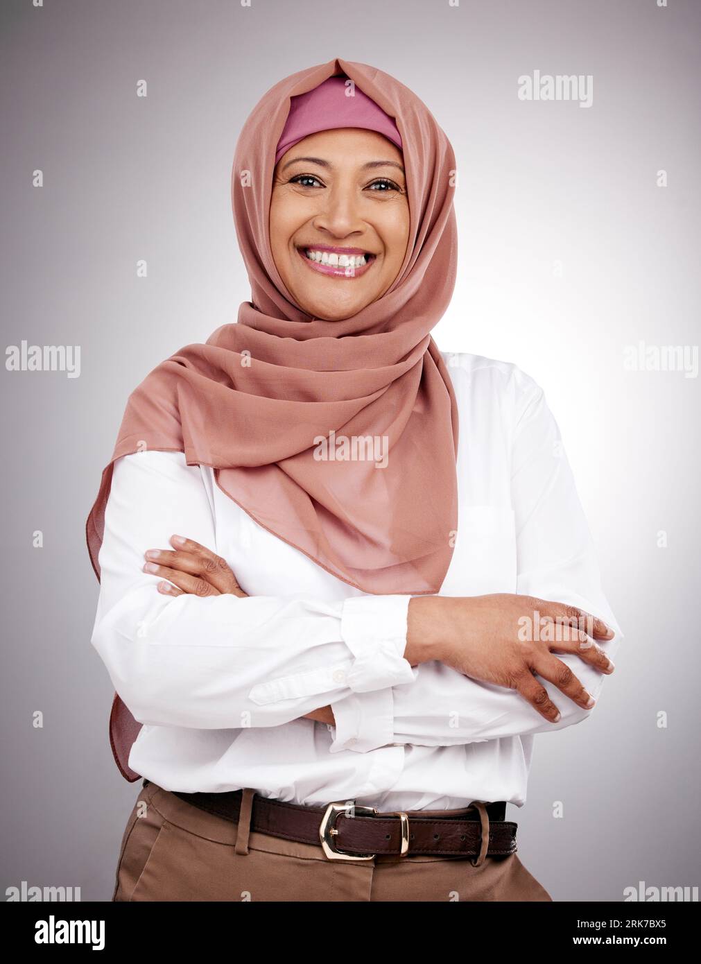 Muslim, arms crossed and portrait and woman in studio with happiness ...