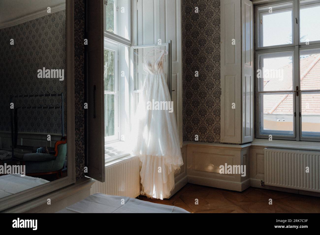 An inviting, sun-drenched bedroom with an open window with a white ...