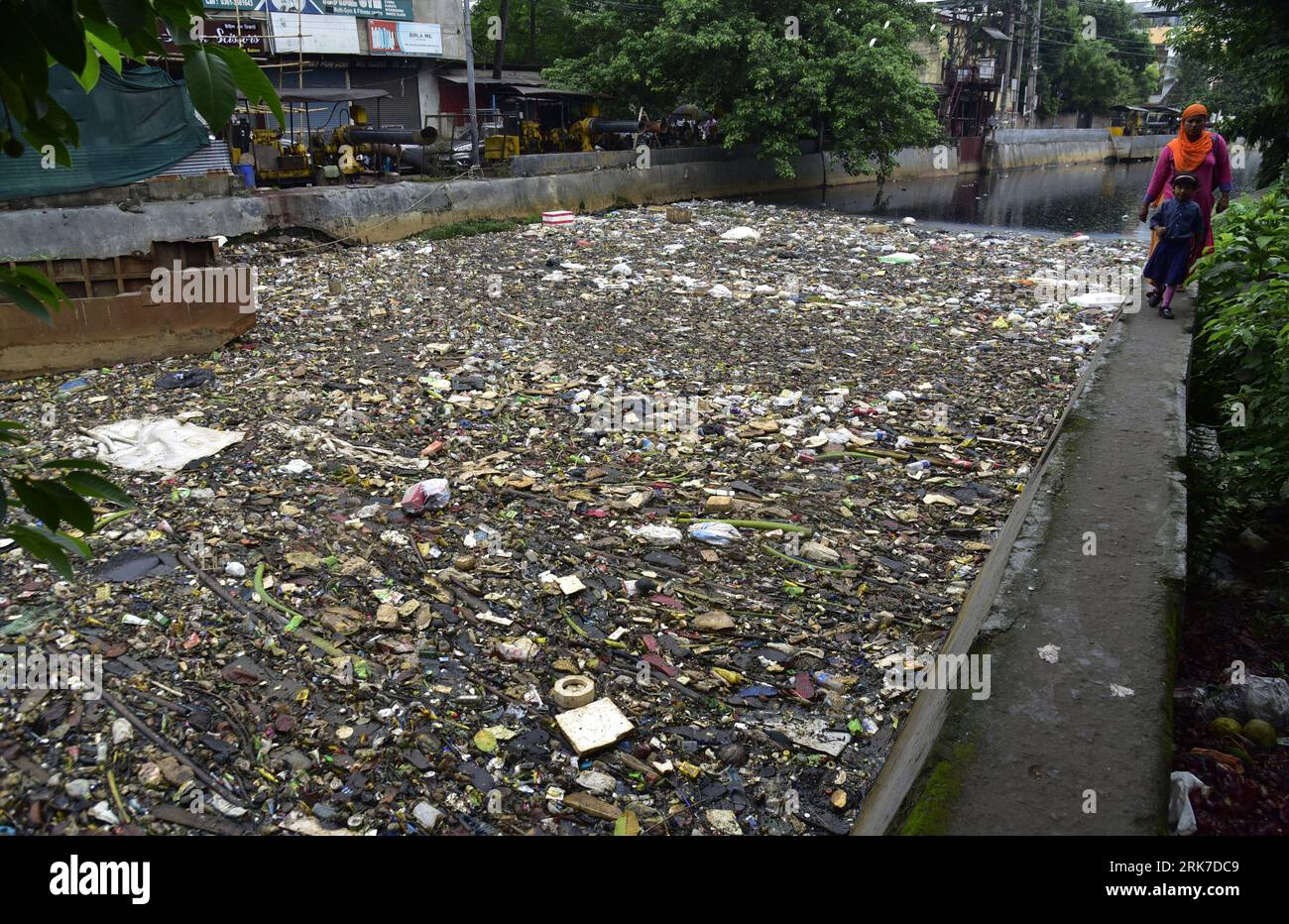 Guwahati, India. 24th Aug, 2023. A mother and daughter walk through the ...