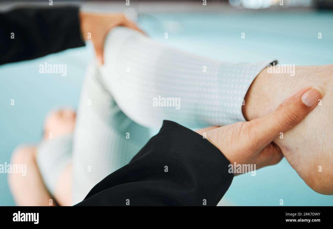 Ankle pain, fitness and coach with athlete in gymnastics, people in gym ...