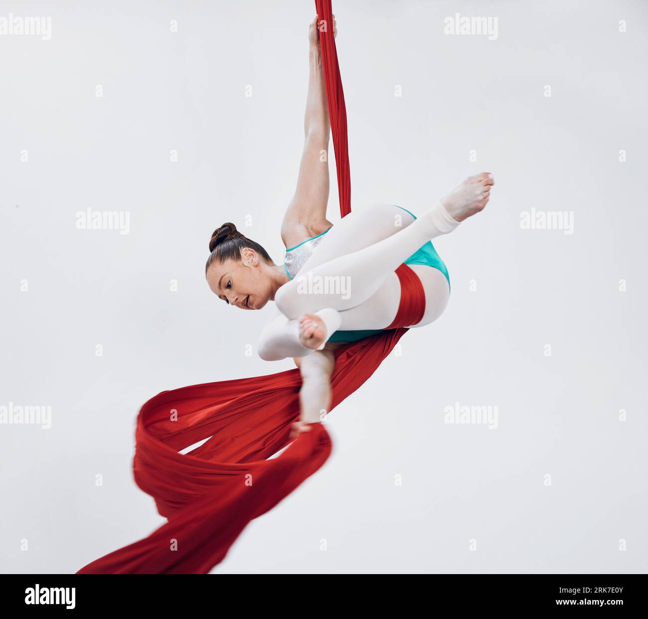 Acrobat, gymnastic and aerial silk with a woman in air for performance ...