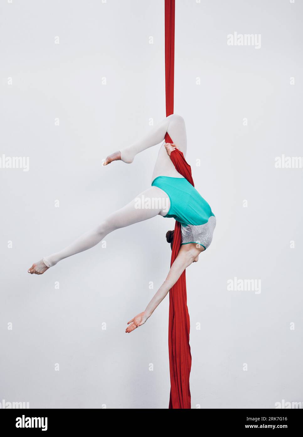 Aerial silk, acrobat and gymnastics with a woman in air for performance ...
