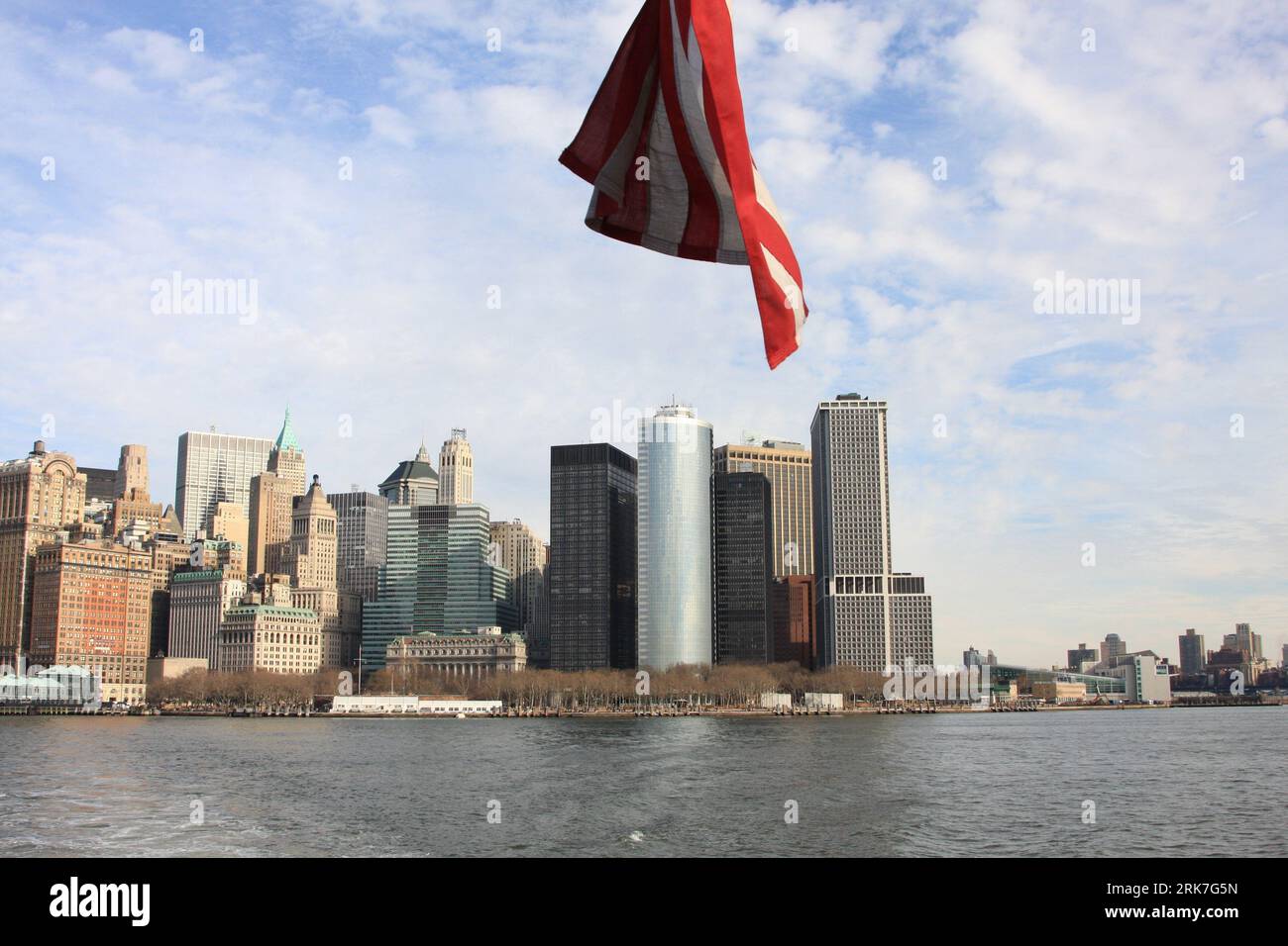 The Skyline Of New York City With The American Flag In Foreground Stock