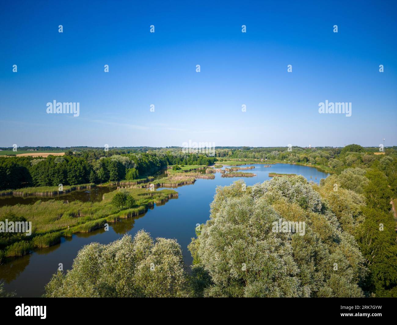 A scenic aerial view of a river meandering through a lush green ...