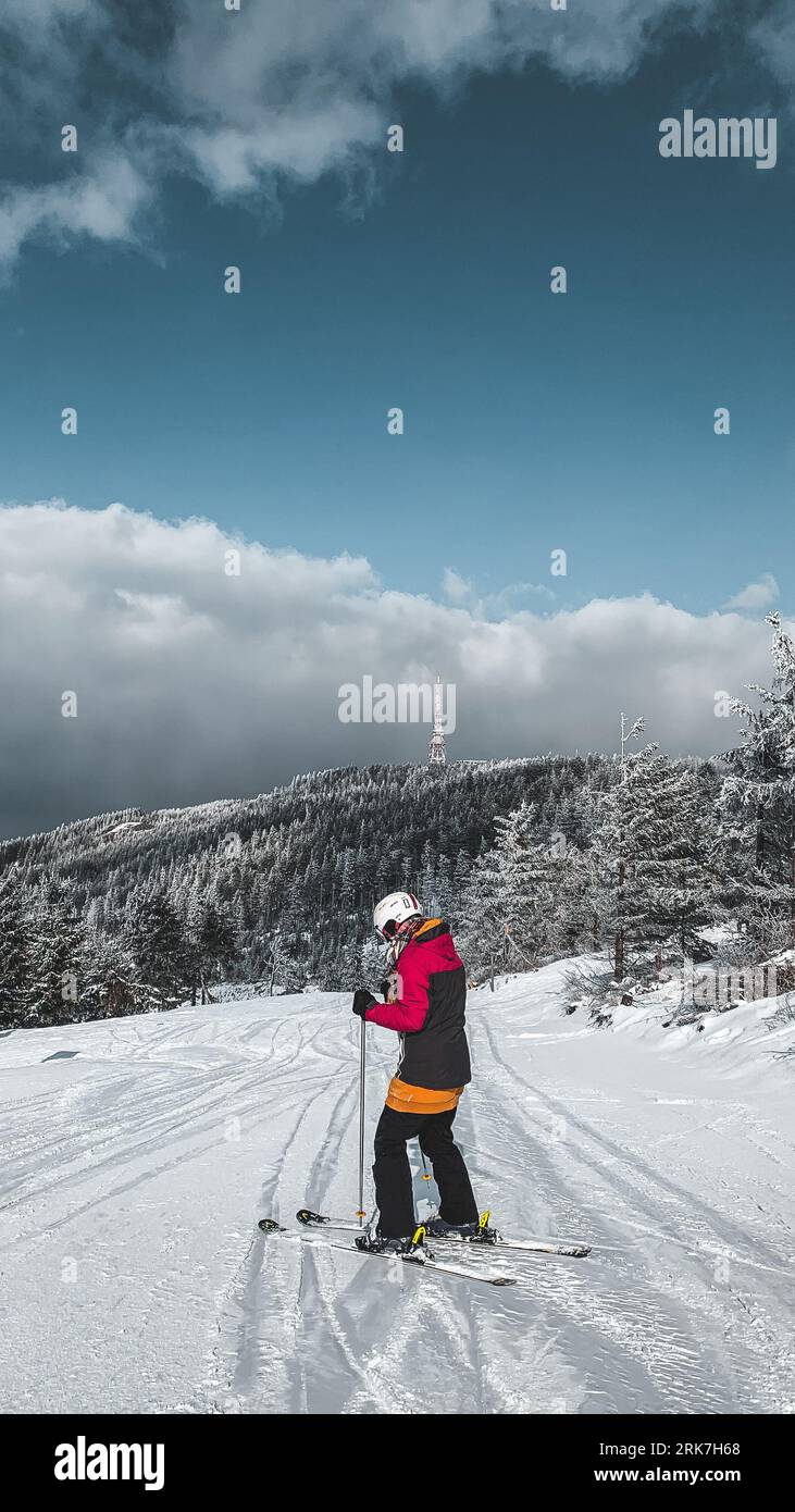 A vertical of a person skiing on a snowy mountain in Szczyrk, Poland ...