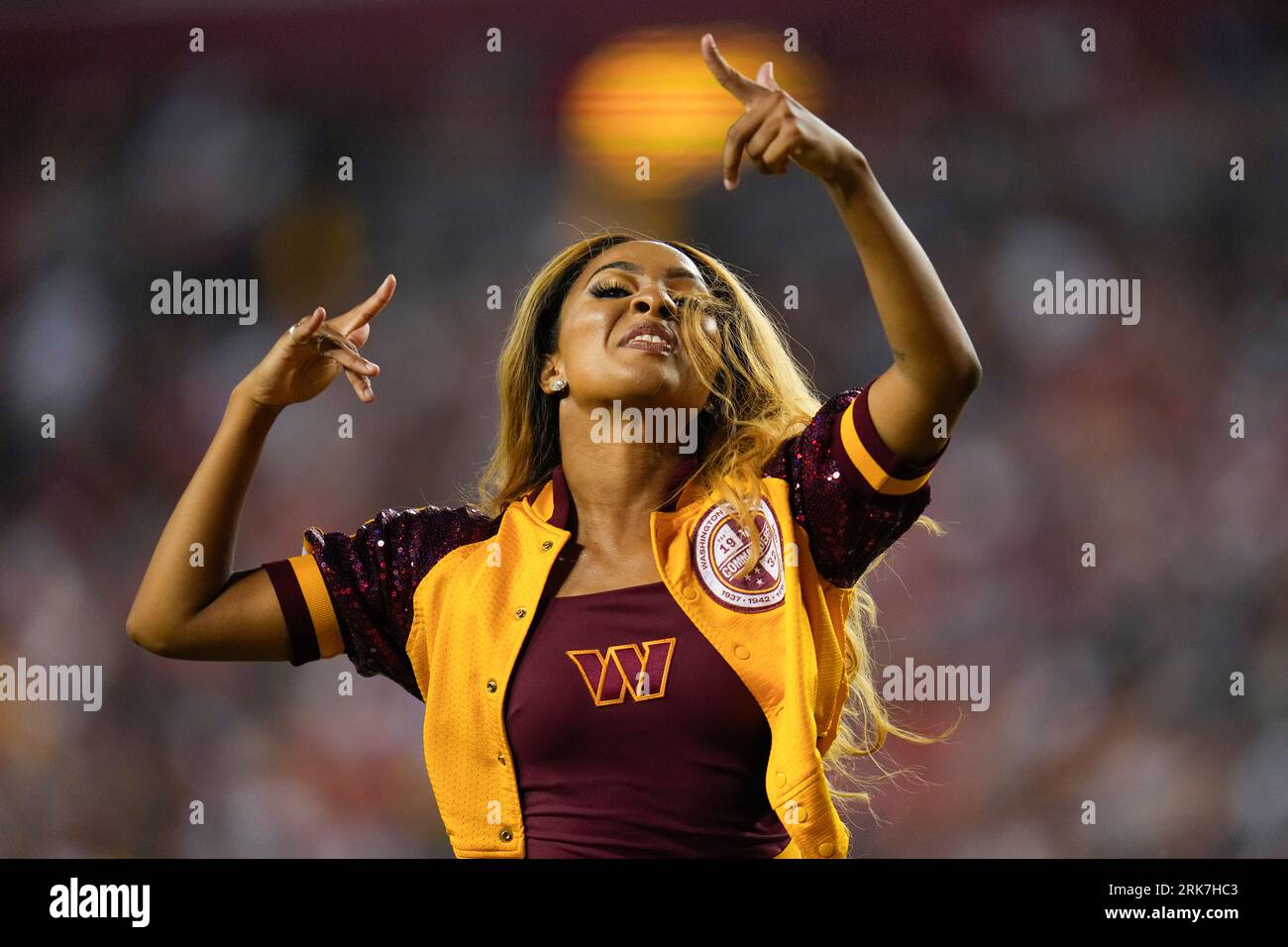 A Washington Commanders cheerleader performs during the first half of ...