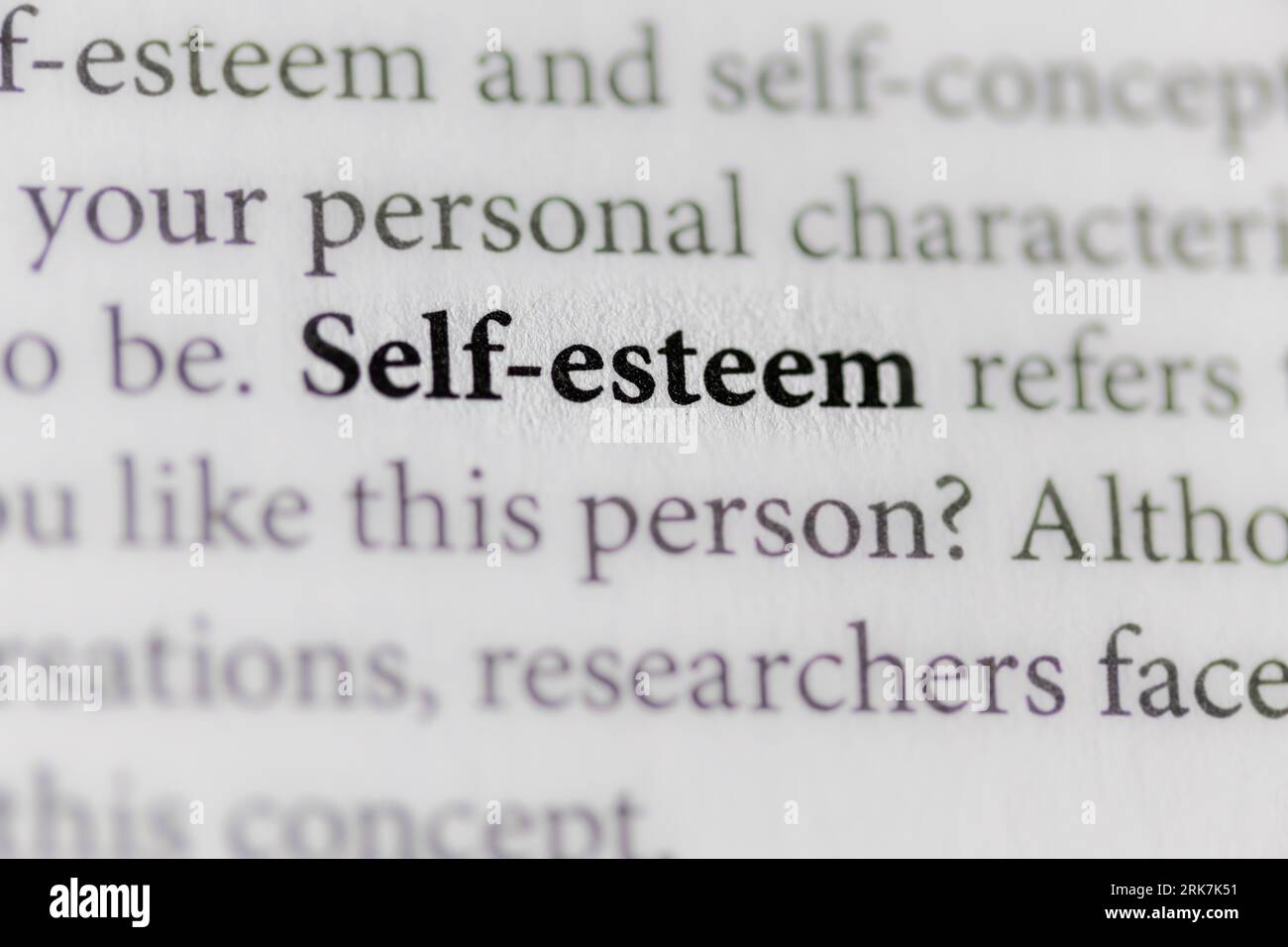 An open book with the word 'Self-Esteem' written on the page in bold ...