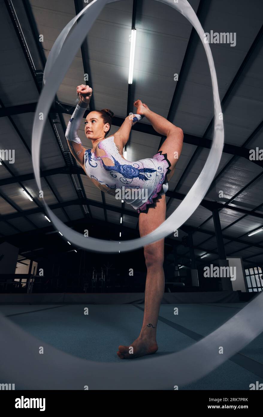 Woman, dancer and balance for ribbon gymnastics in competition, sports ...