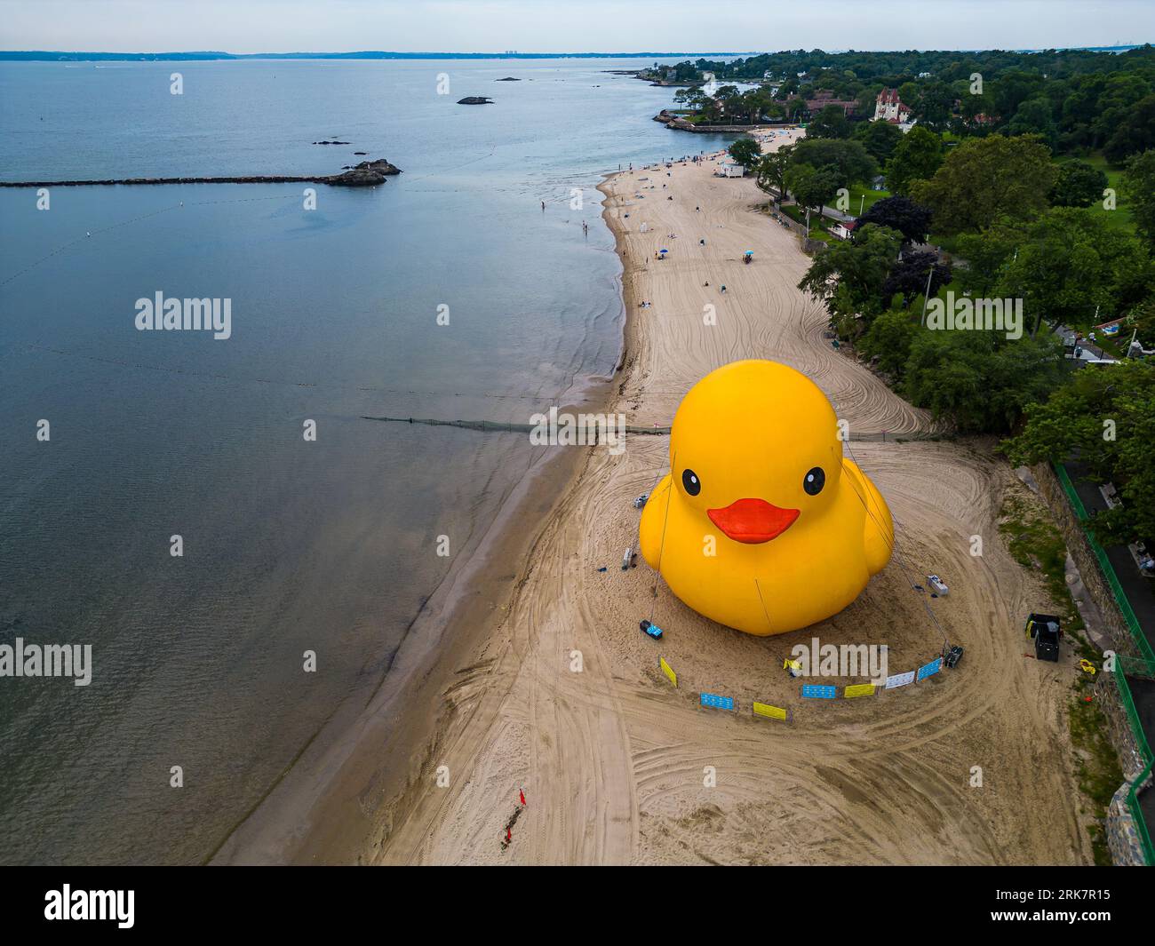 An aerial view of an enormous yellow rubber duck on the beach near the ...