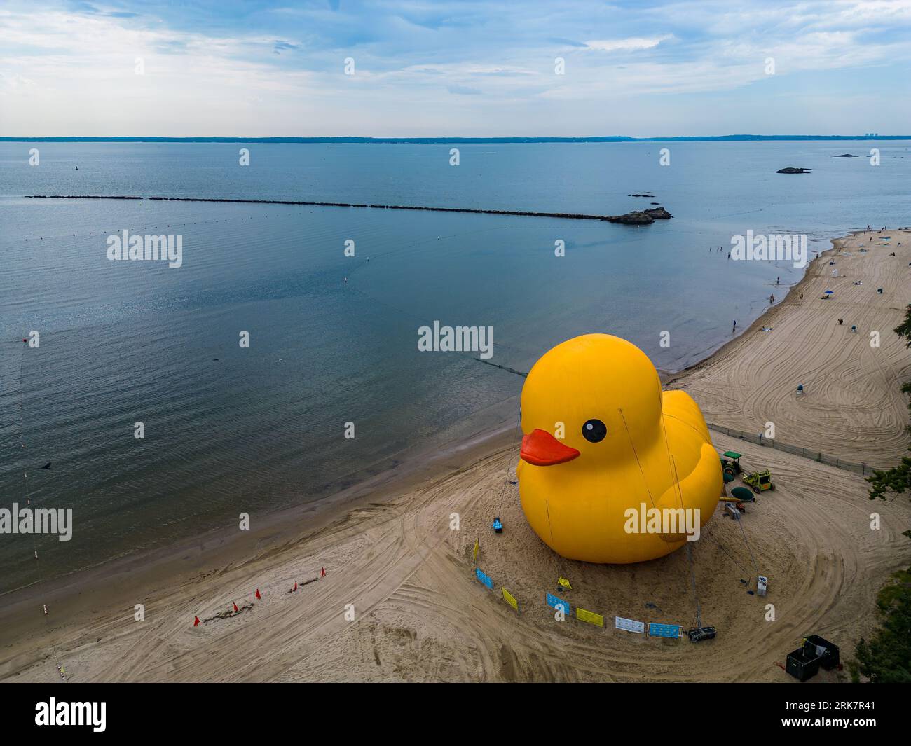 An aerial view of an enormous yellow rubber duck on the beach near the ...