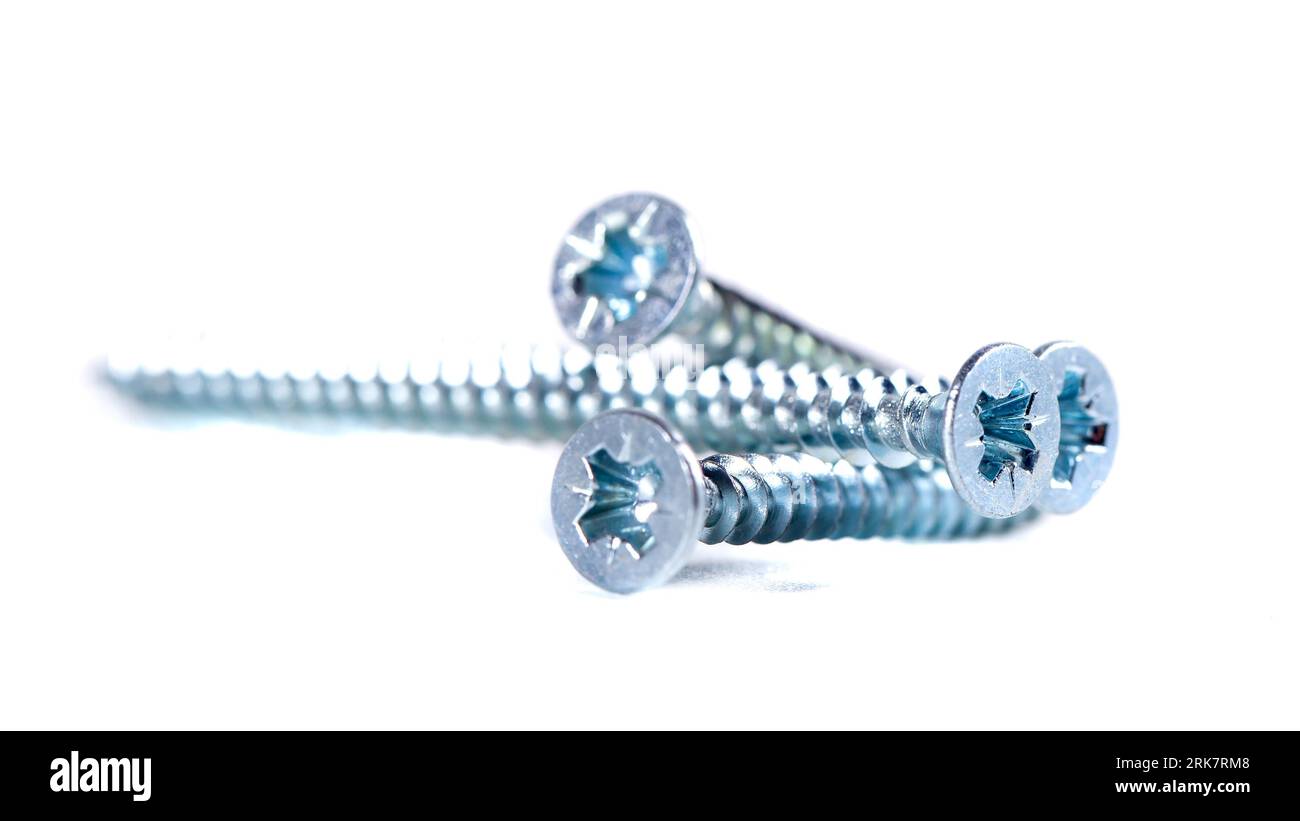 Chrome screw on white background. Self-tapping screws from steel close ...