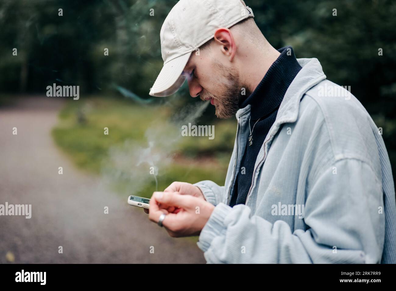 Man smoking cigarette in the forest hi-res stock photography and images ...