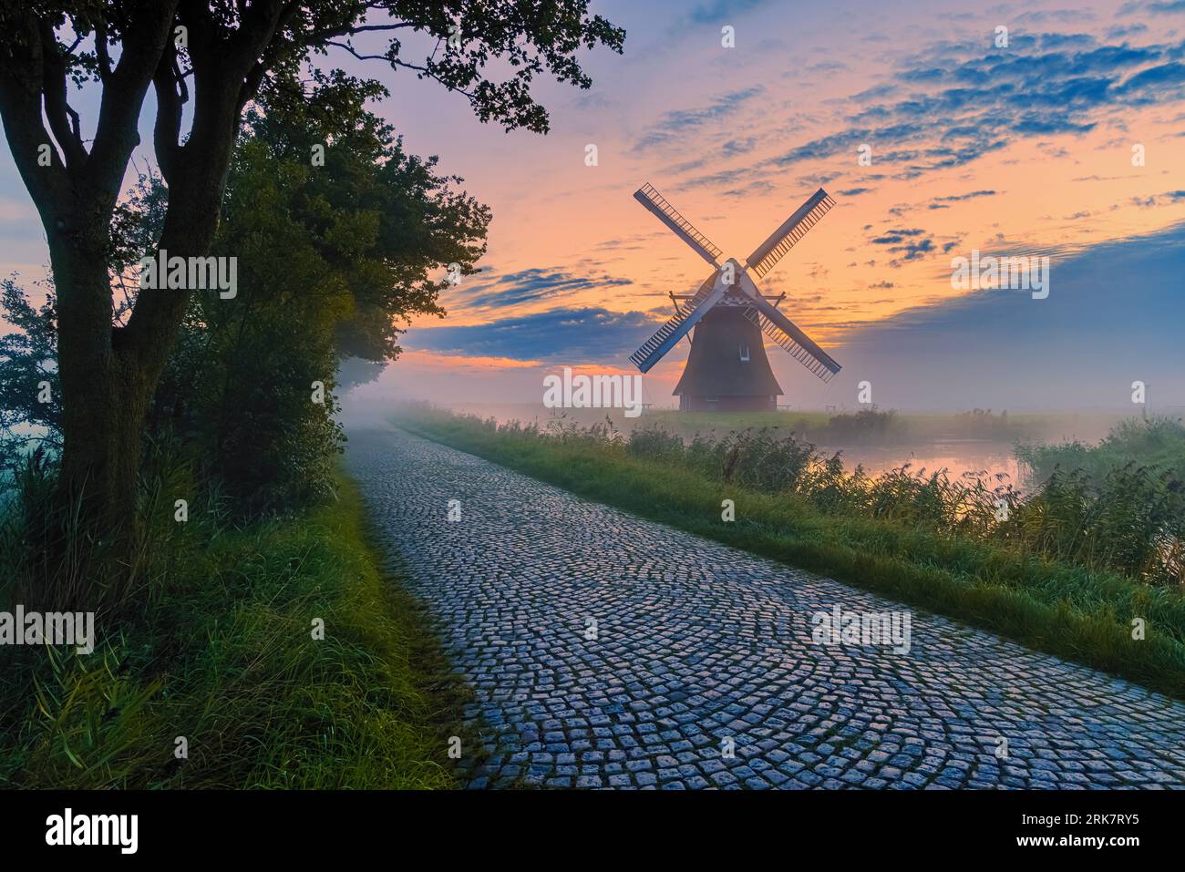 A horizontal photo of a beautiful summer morning with a layer of fog ...