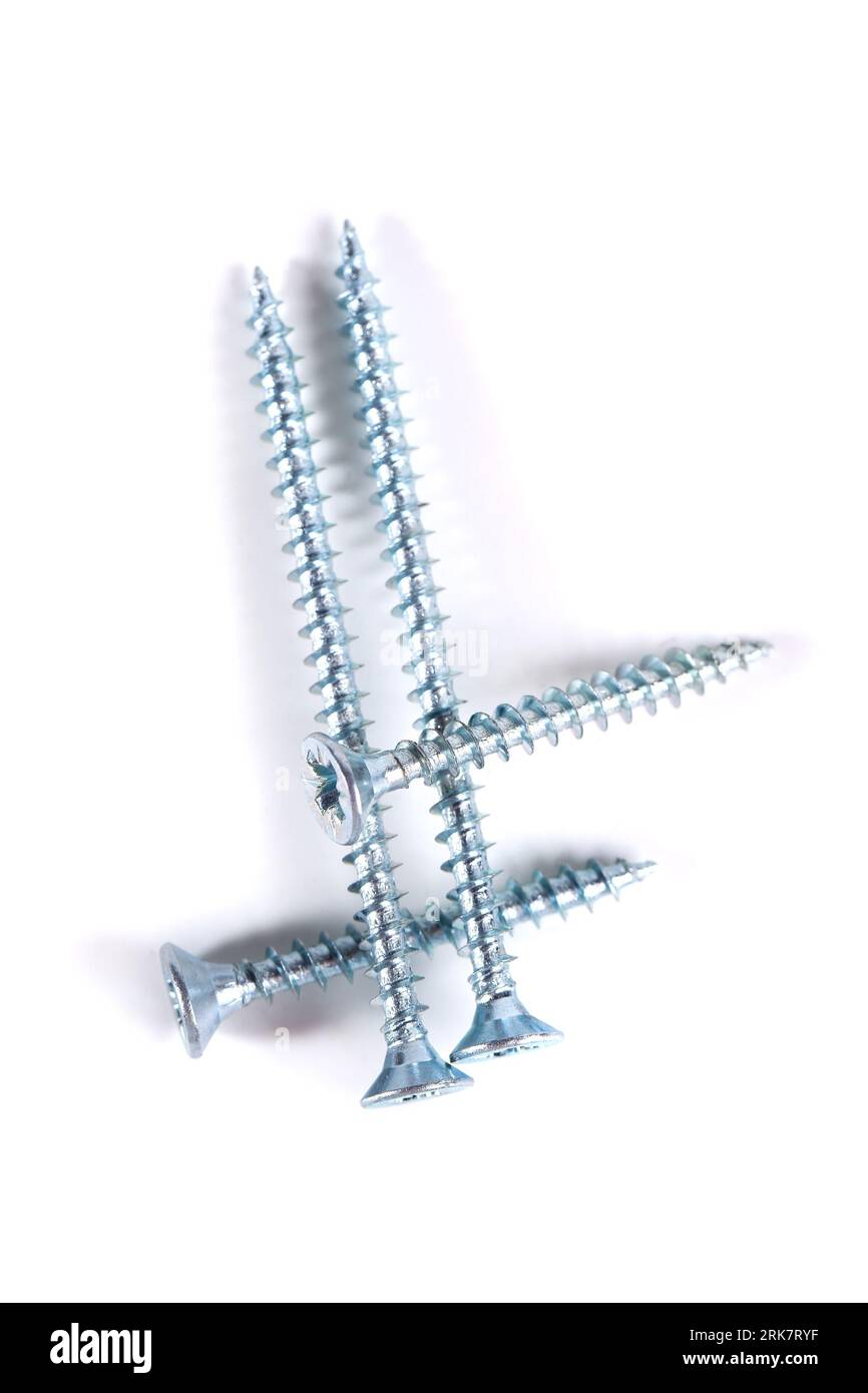Chrome screw on white background. Self-tapping screws from steel close ...