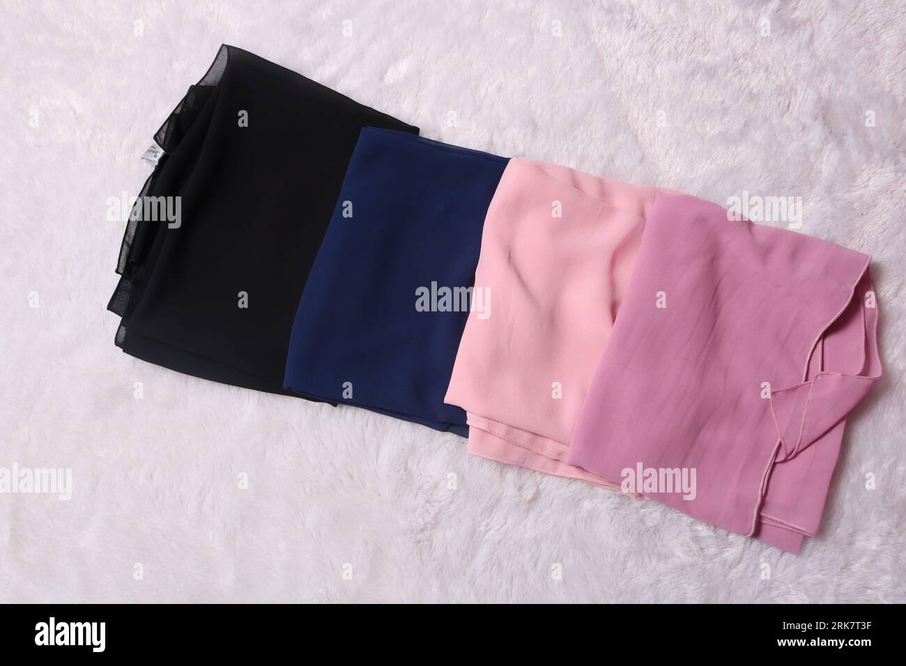 folded hijab on white background. colour variation of pashmina, hijab ...