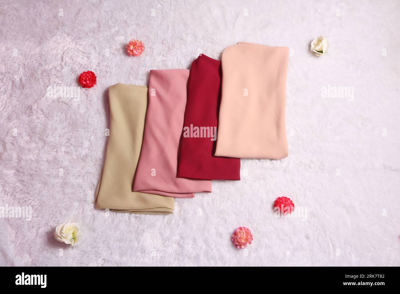 folded hijab on white background. colour variation of pashmina, hijab ...