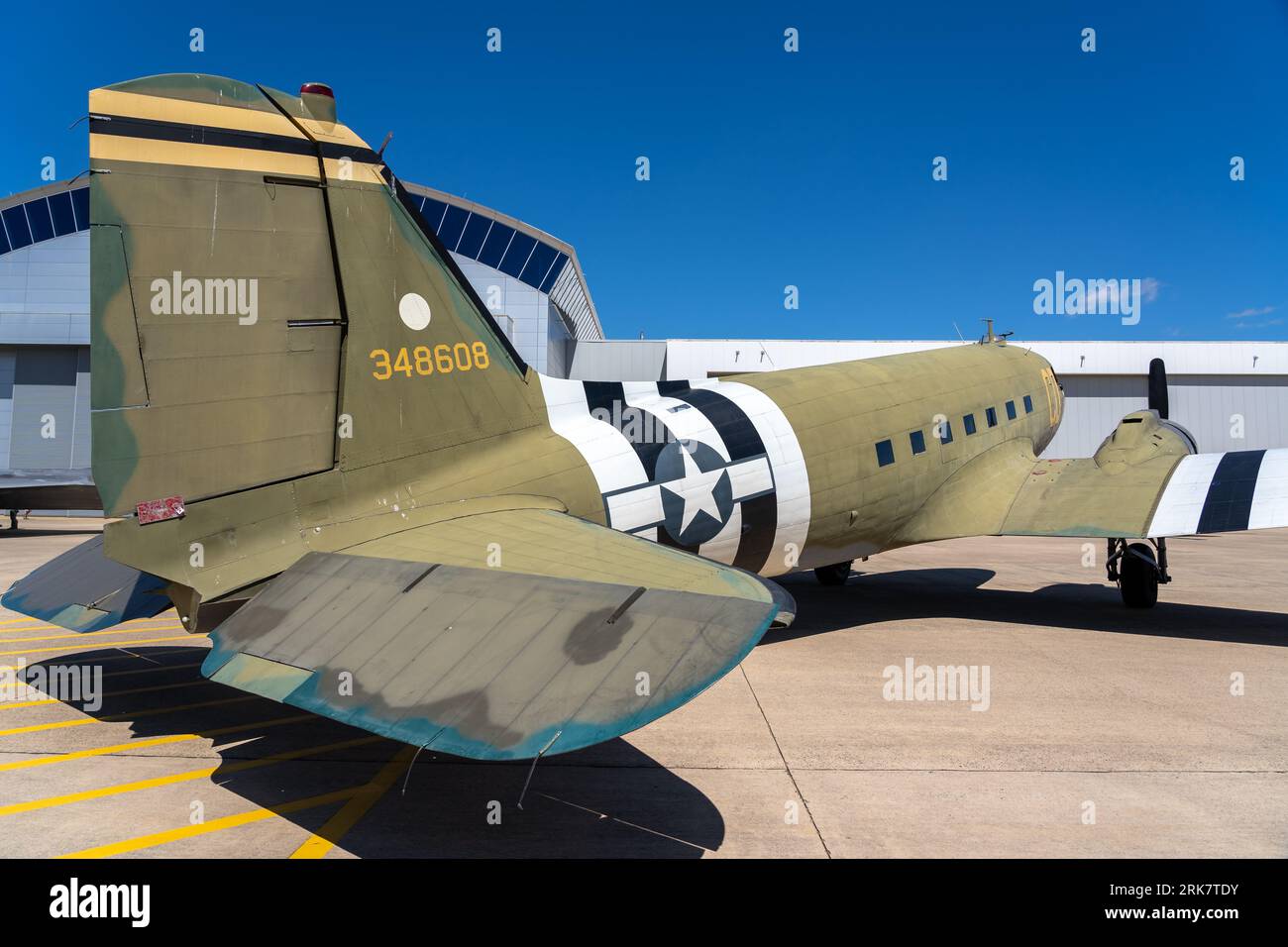 A close-up shot of a vintage military DC3 aircraft in a landing zone ...