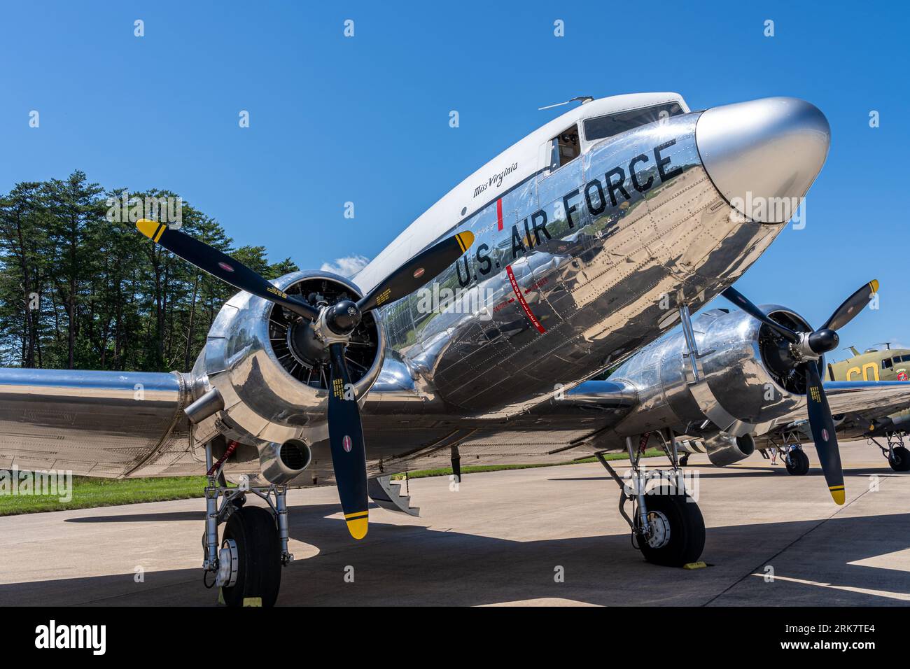 A close-up shot of a vintage military DC3 aircraft in a landing zone ...
