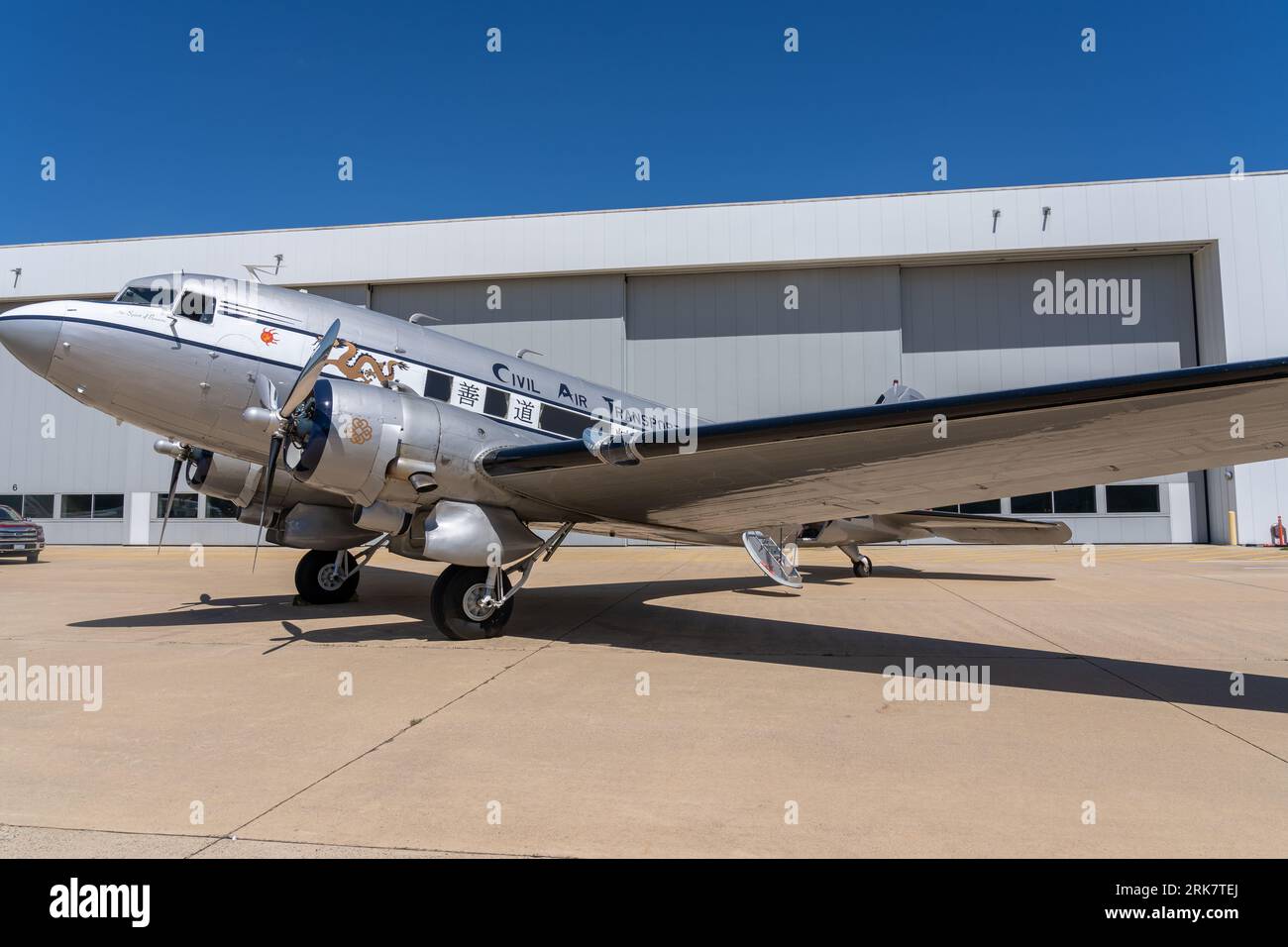 A close-up shot of a vintage military DC3 aircraft in a landing zone ...
