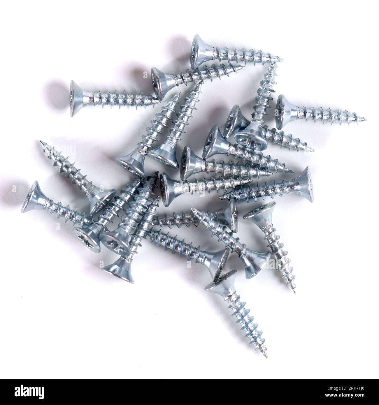 Chrome screw on white background. Tapping screws from steel close-up ...