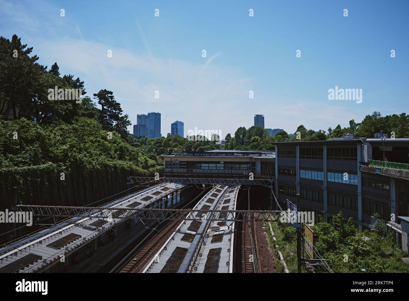 A bustling train station in Tokyo, Japan, surrounded by towering ...