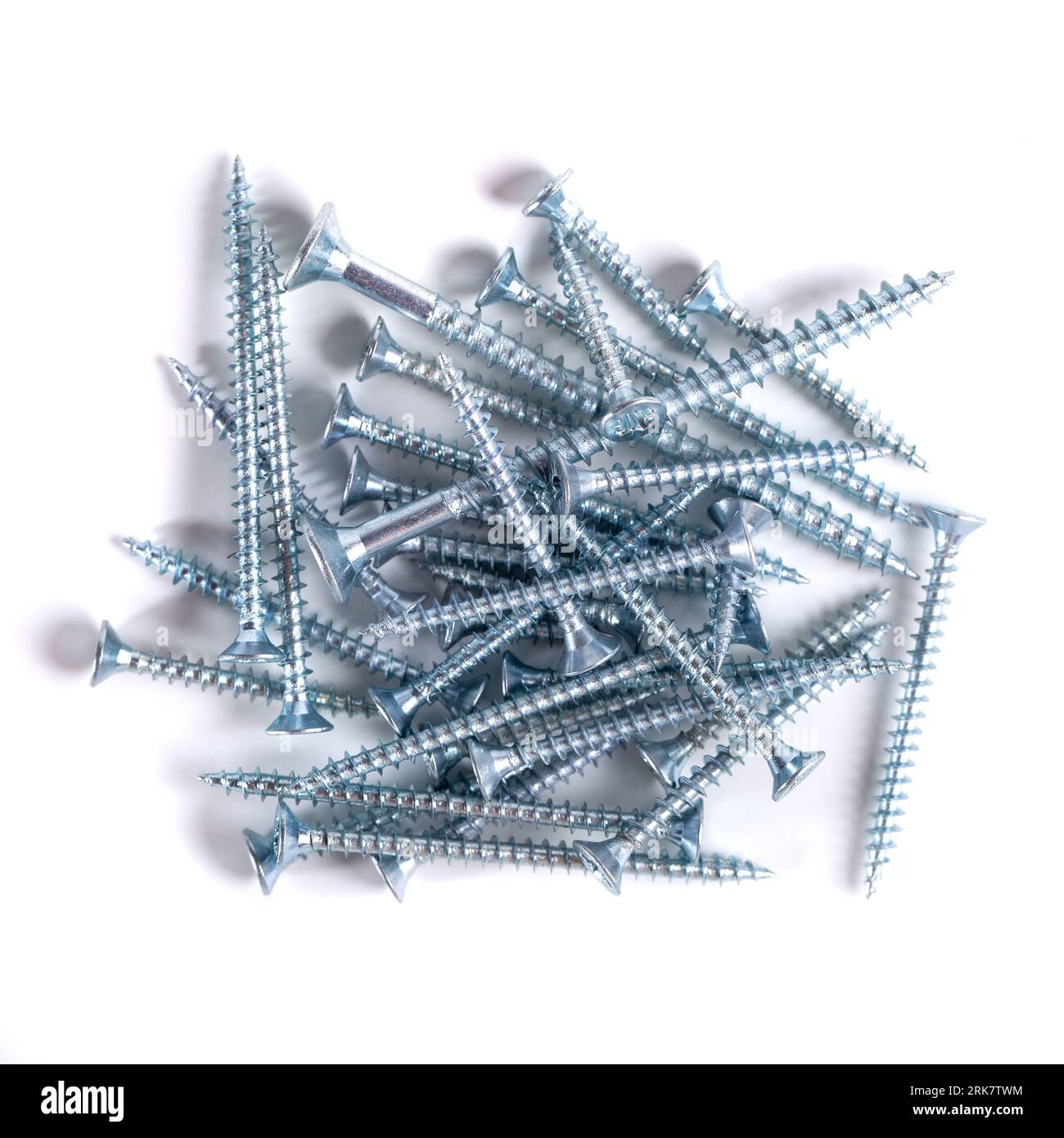 Chrome screw on white background. Tapping screws from steel close-up ...