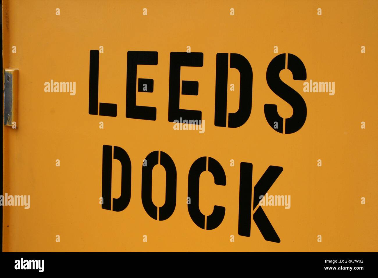 A vibrant yellow door with the words 'Leeds Dock' painted in black ...