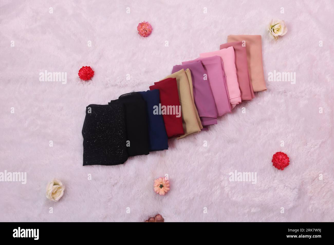 folded hijab on white background. colour variation of pashmina, hijab ...