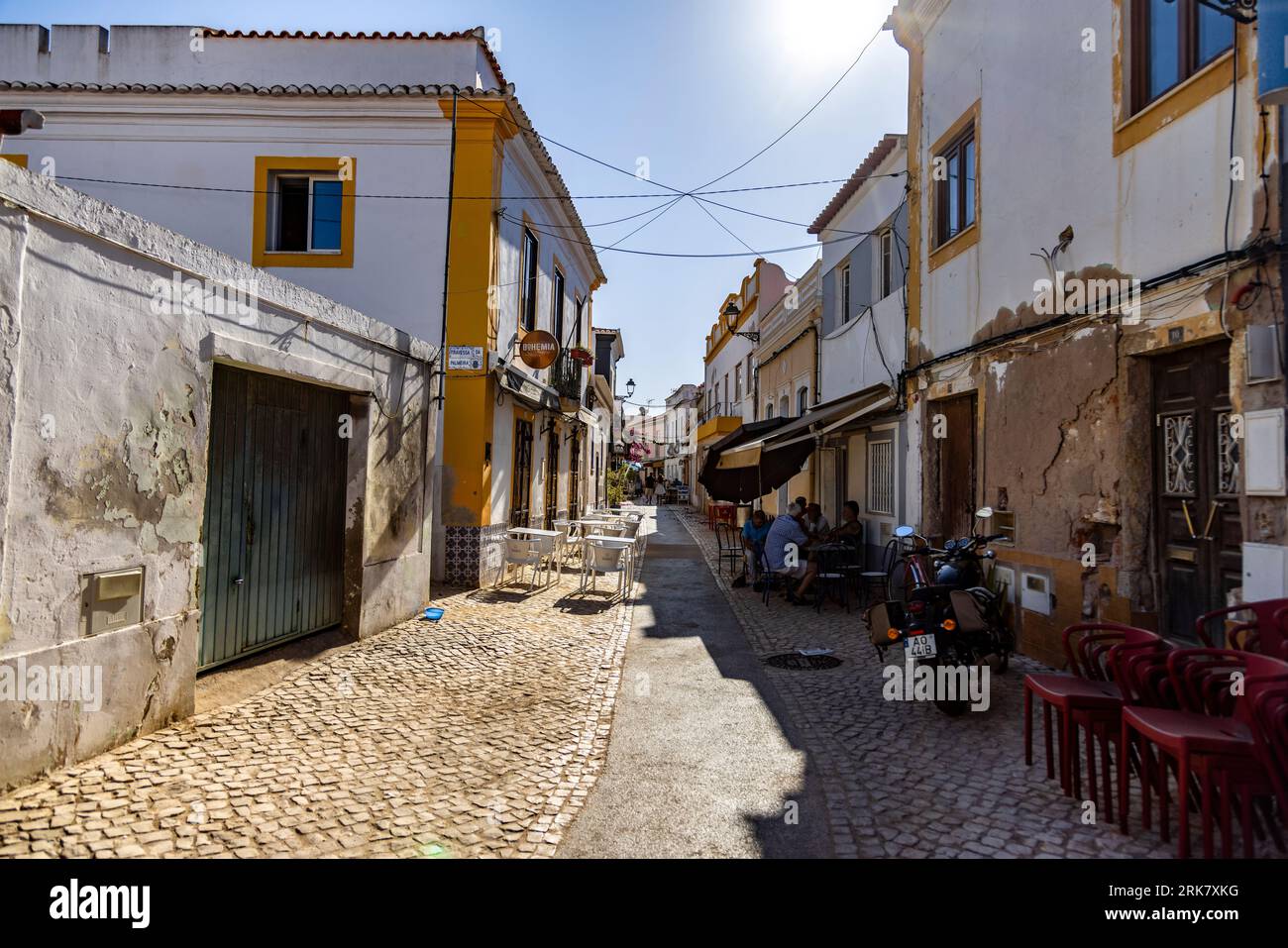 An outdoor urban street scene featuring persons walking along a ...