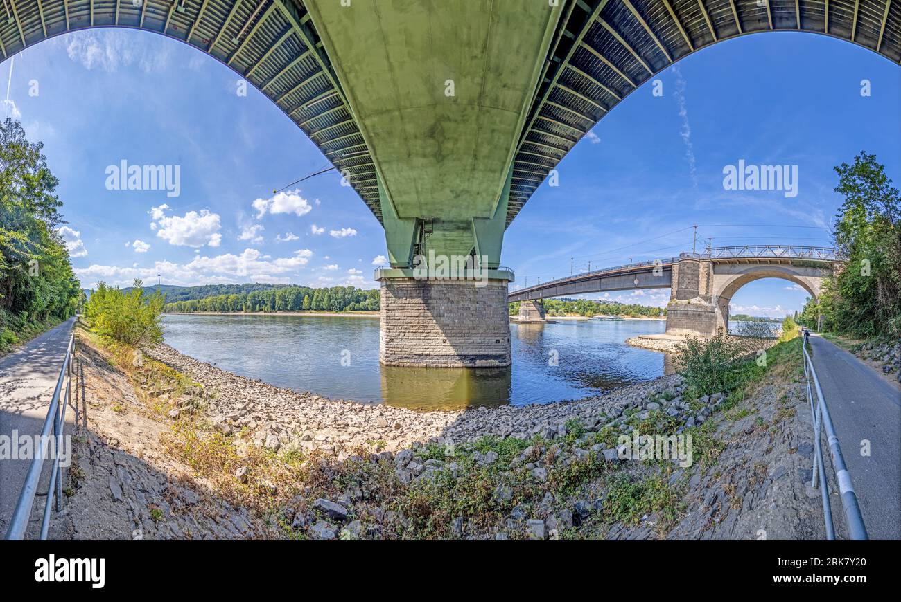 A wide-angle shot of a highway bridge from below captures its ...