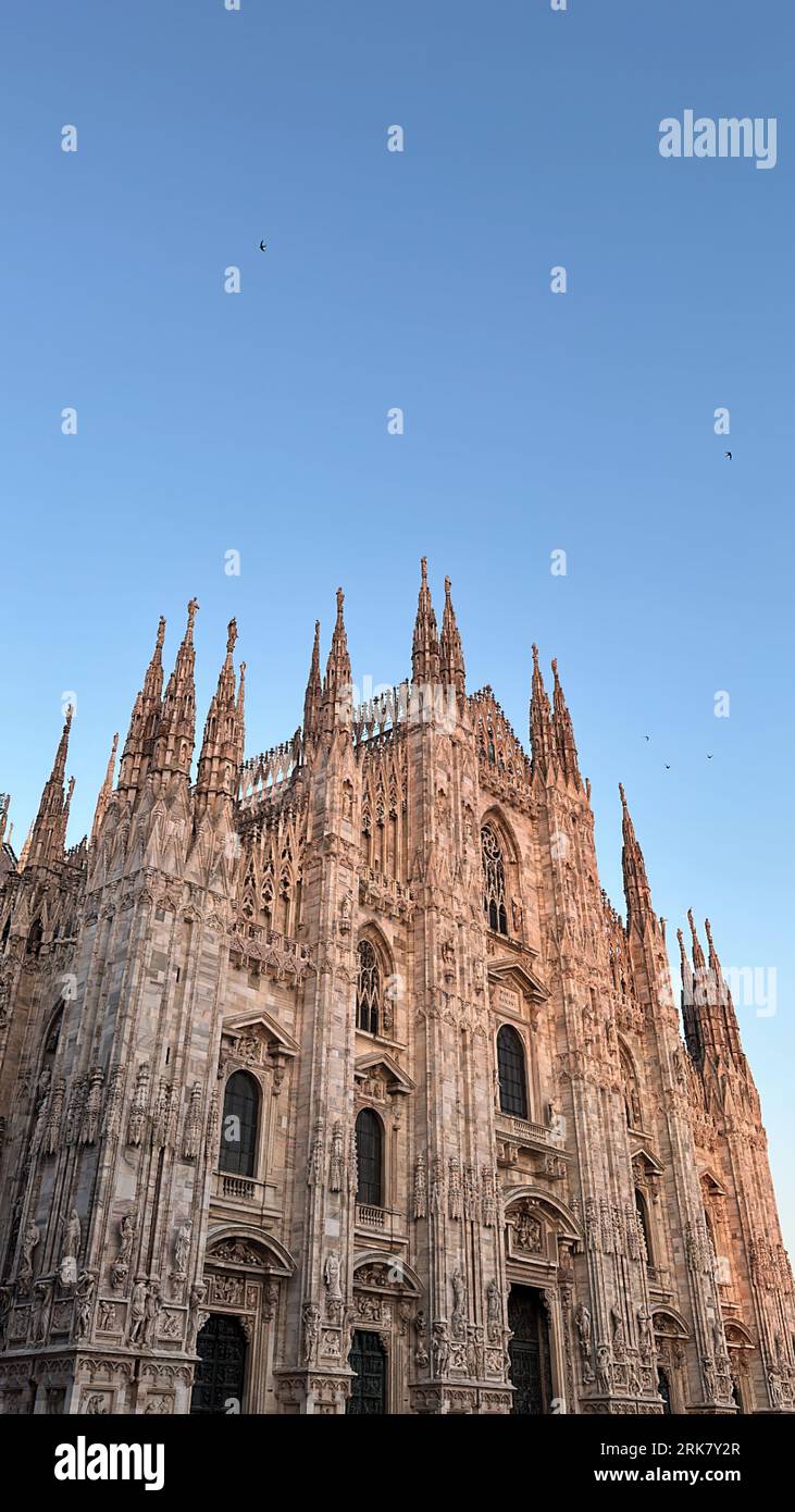 A grand building featuring tall towers and ornate windows with a ...