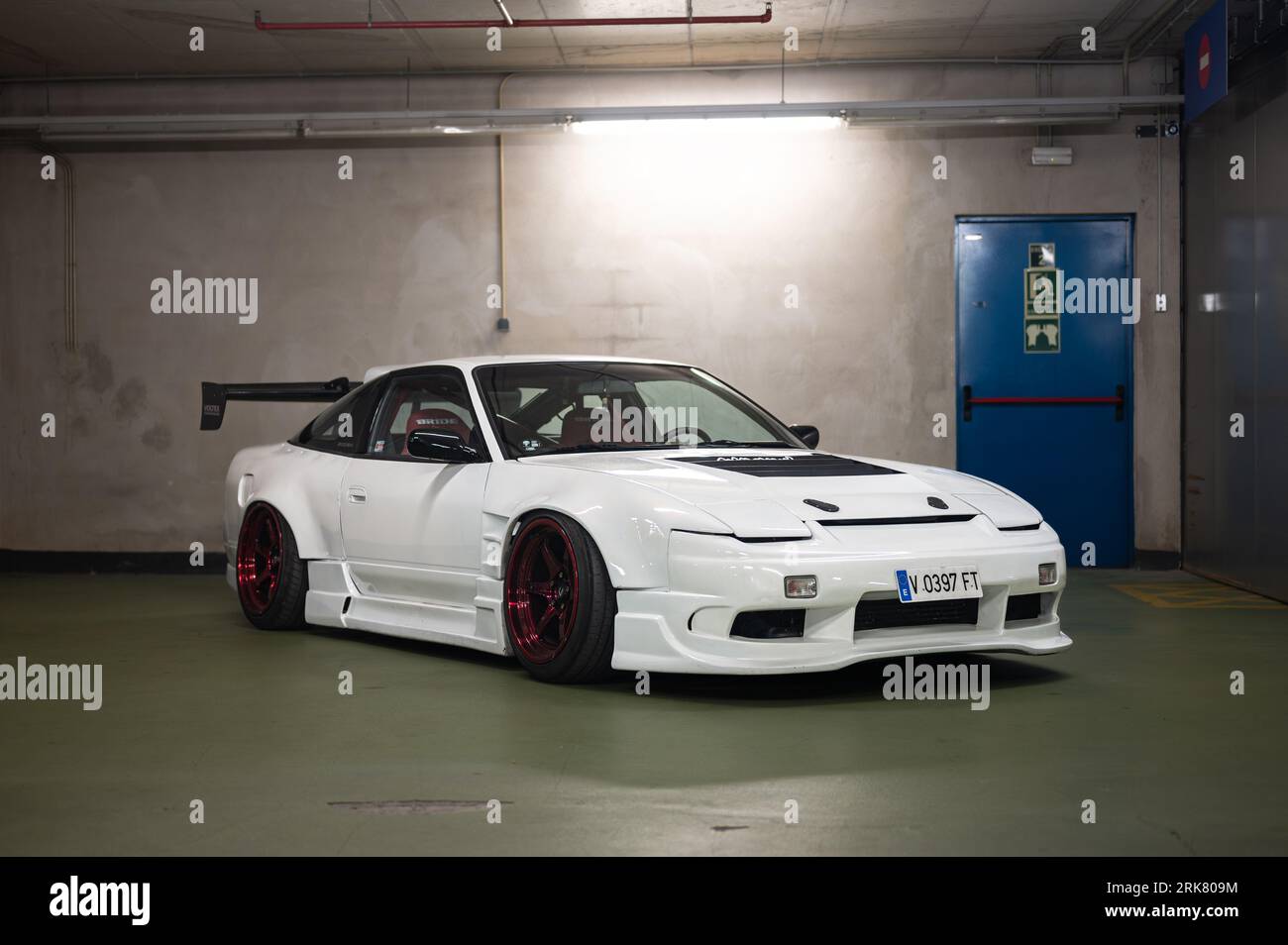 Detail of a white Nissan Silvia S13 with spoiler and body kit in an ...