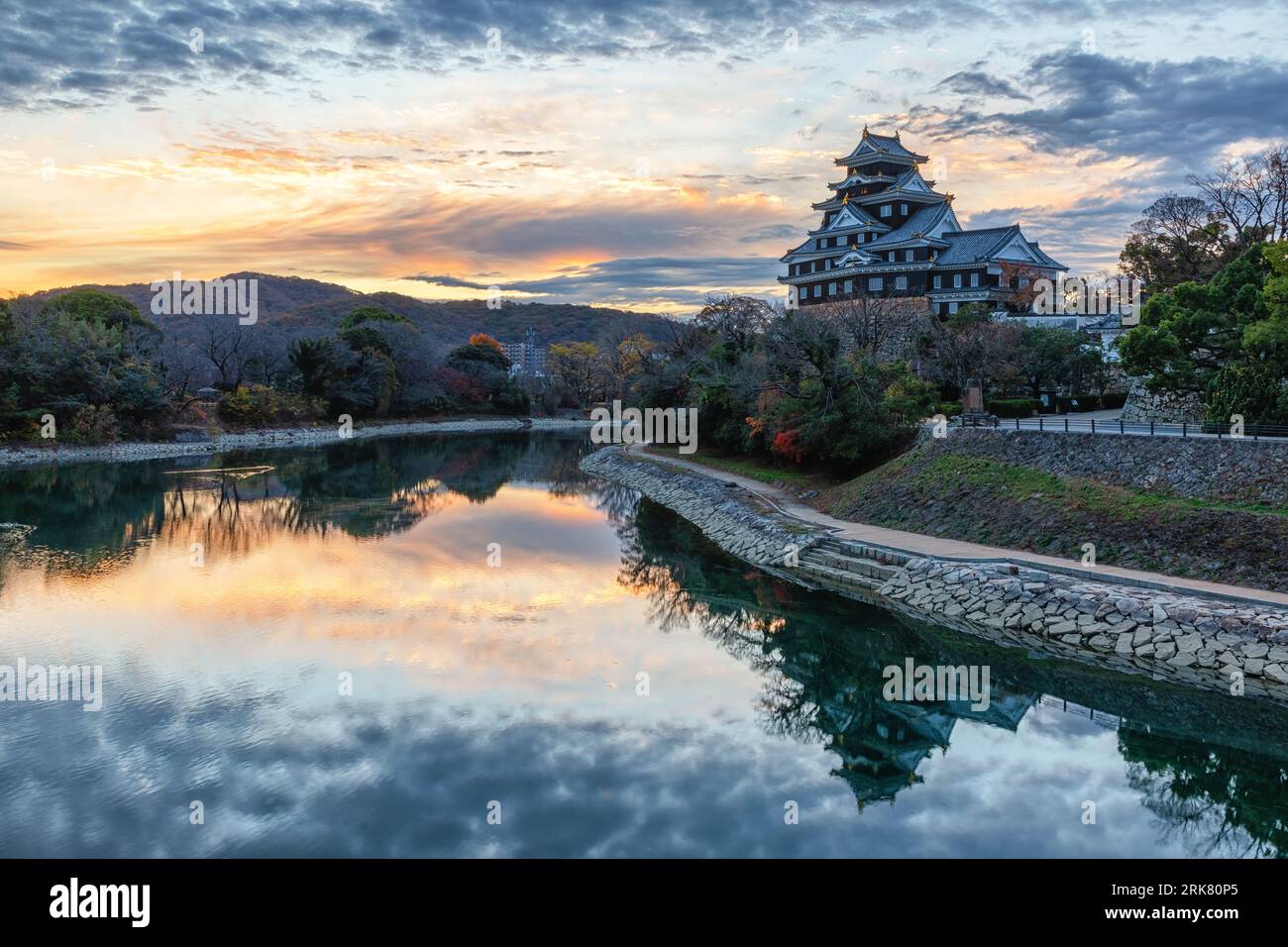 Okayama Castle at sunrise, reflecting in the Asahi River, Japan Stock ...