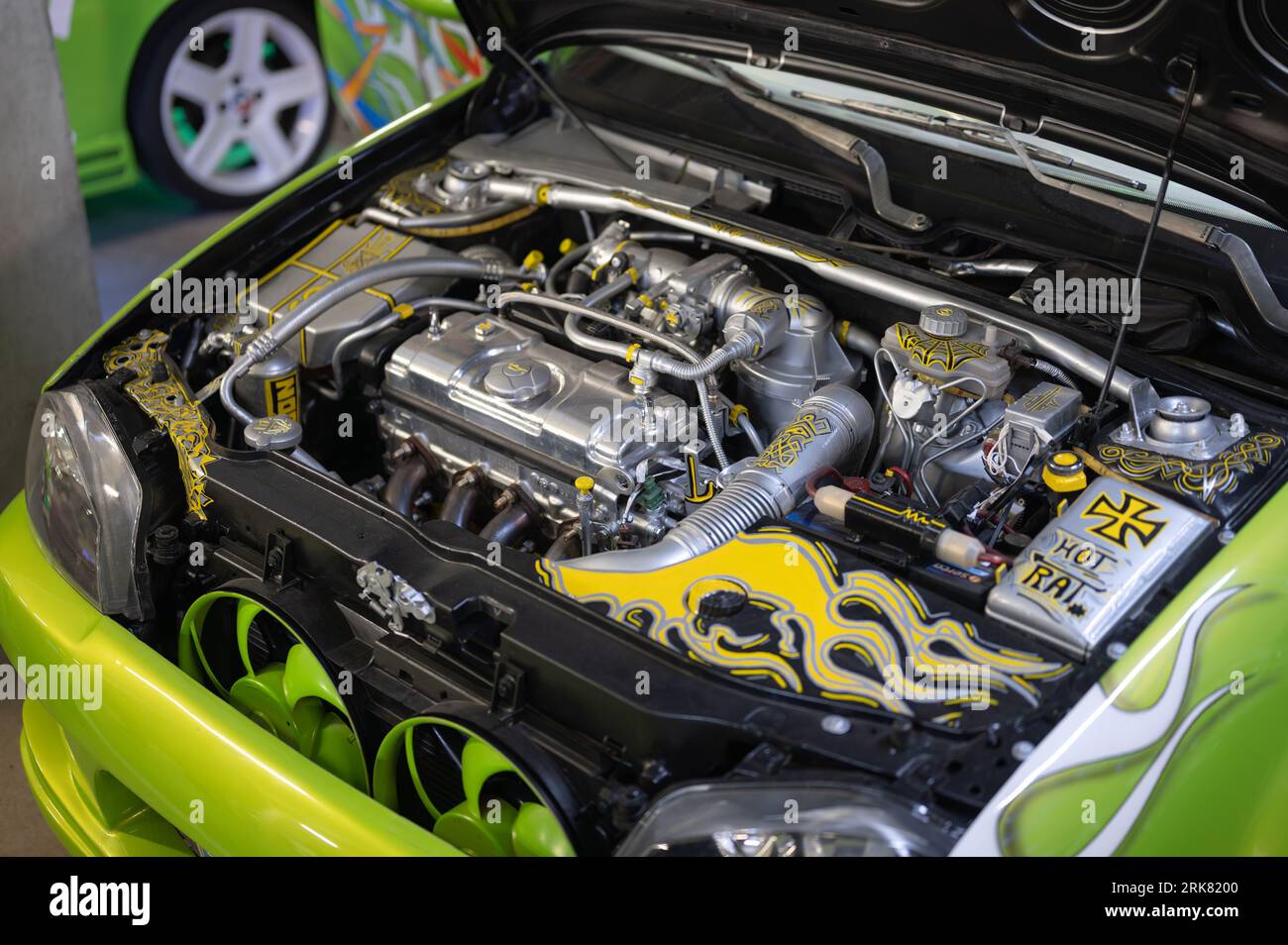 Detail of the engine of a tuned, chromed, green and drawing peugeot ...