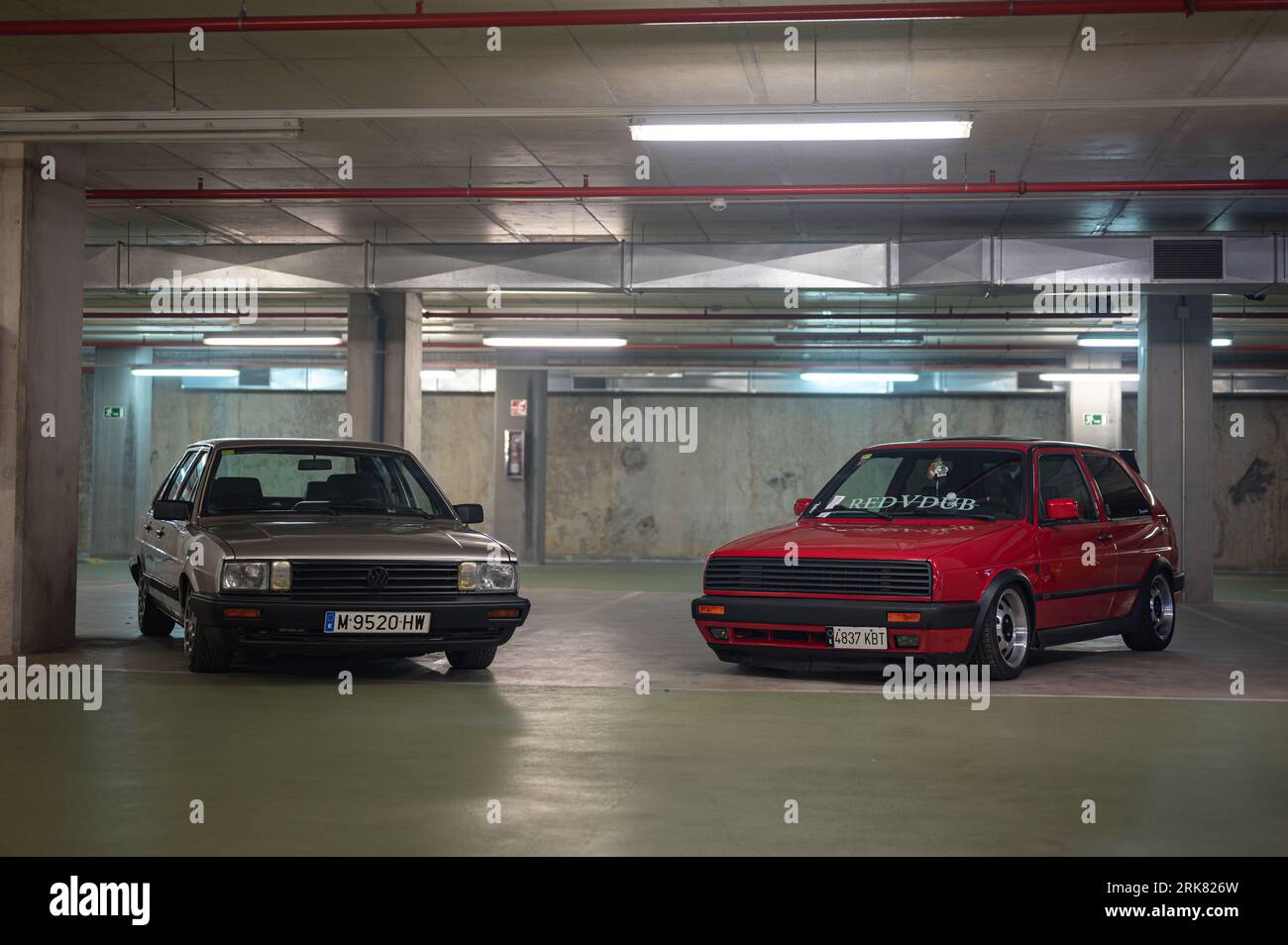 classic silver gray Volkswagen Santana GX5 parked next to a red ...