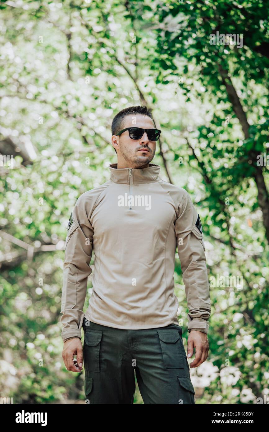A male soldier in a military uniform standing with a neutral expression ...