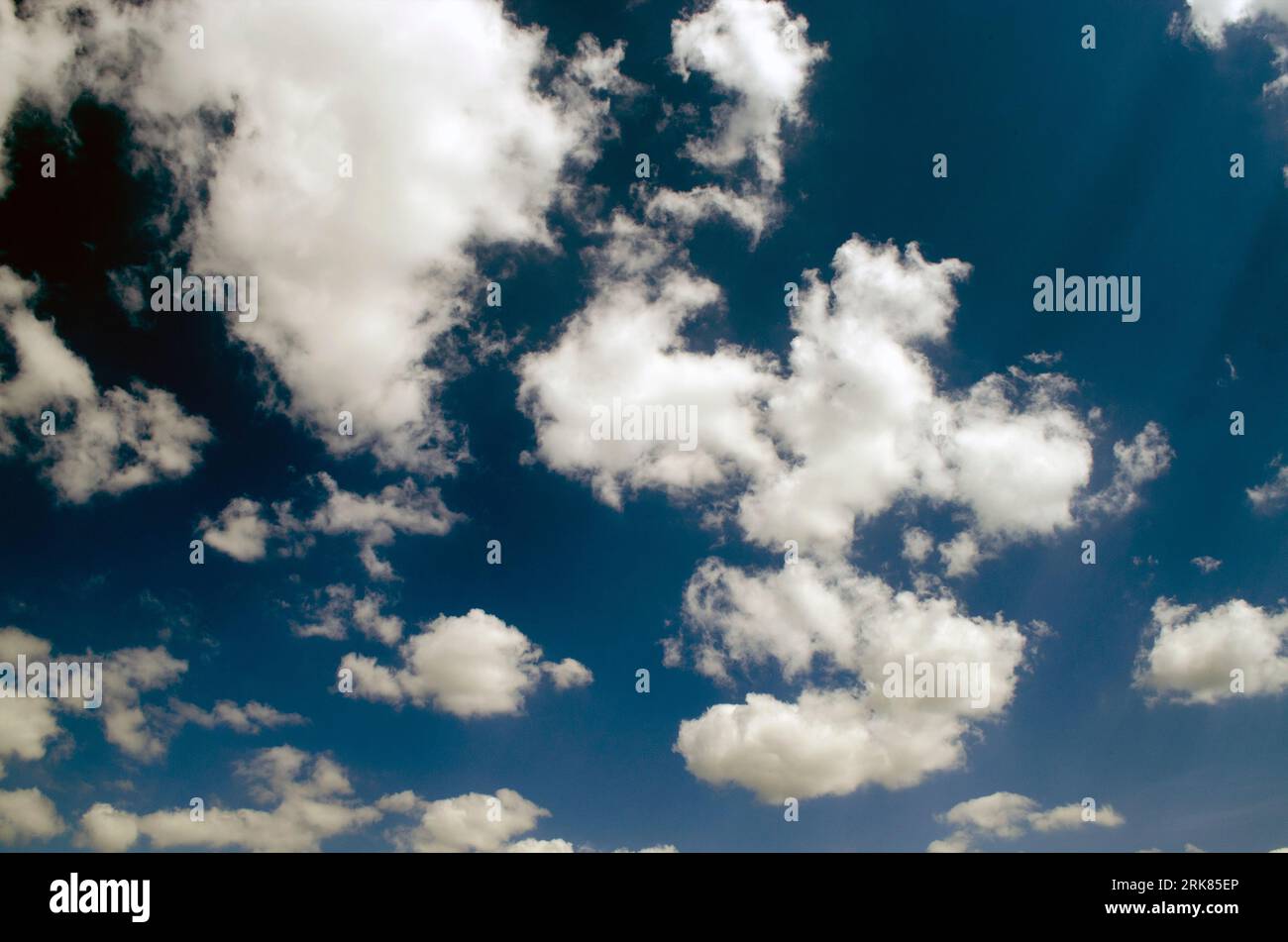 Blue sky with white clouds in sun rays, pure sky background Stock Photo ...