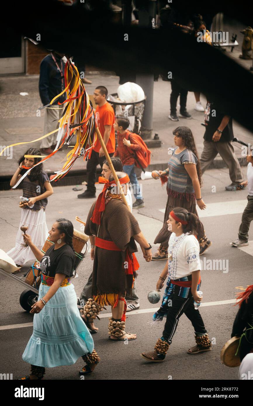 A large group of diverse individuals dressed in traditional costumes ...